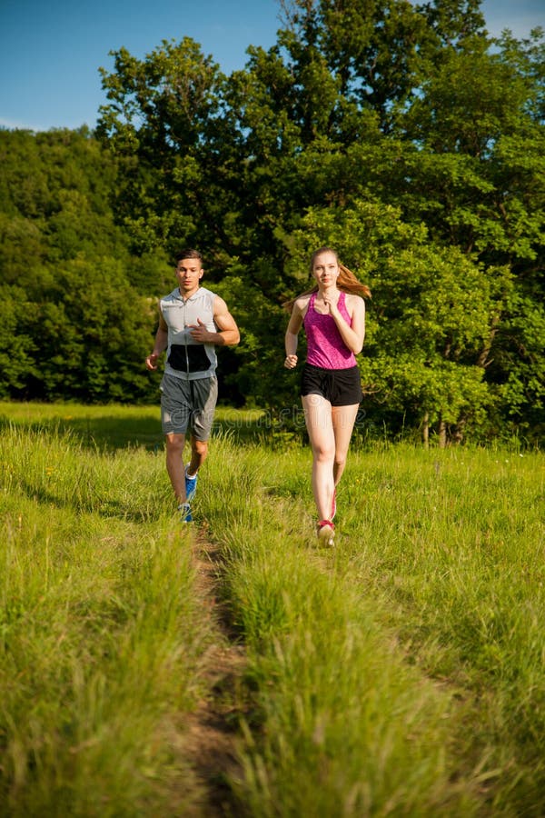 Active Young Couple Running in the Park Stock Photo - Image of ...