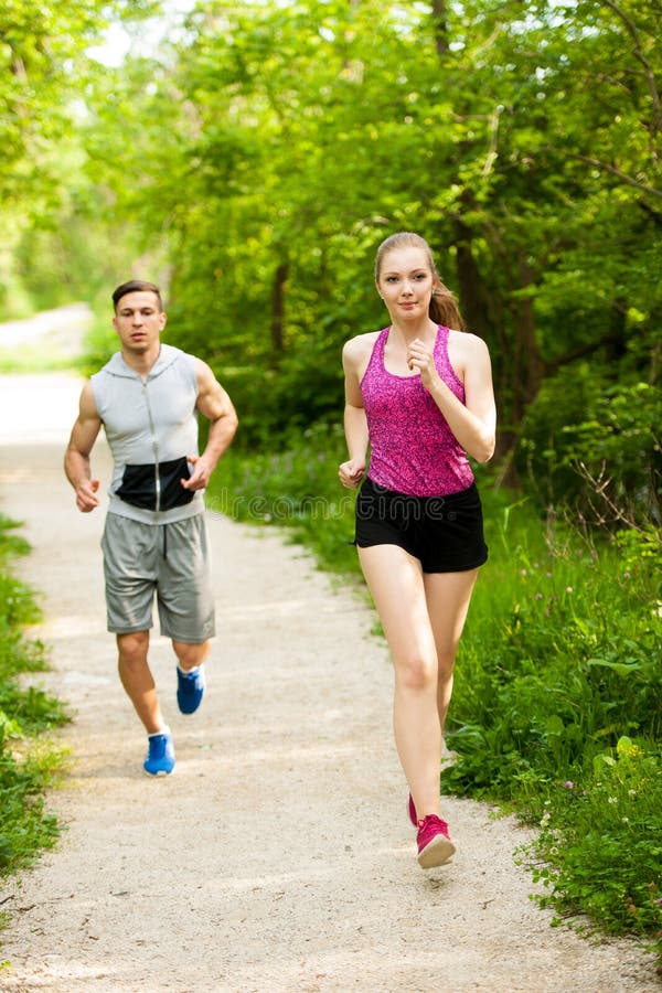 Active Young Couple Running in the Park Stock Image - Image of fitness ...