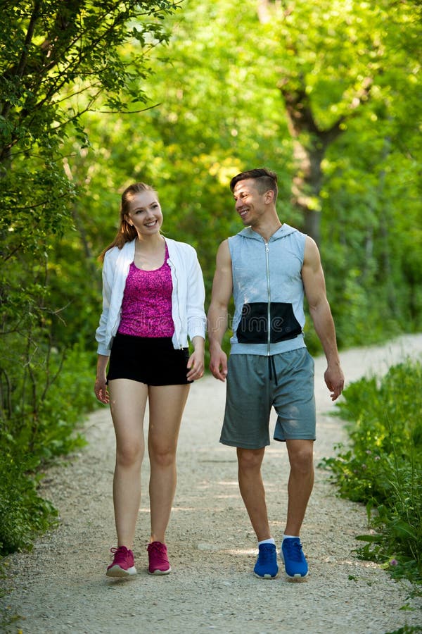 Active Young Couple on a Wlak in the Park Stock Photo - Image of female ...