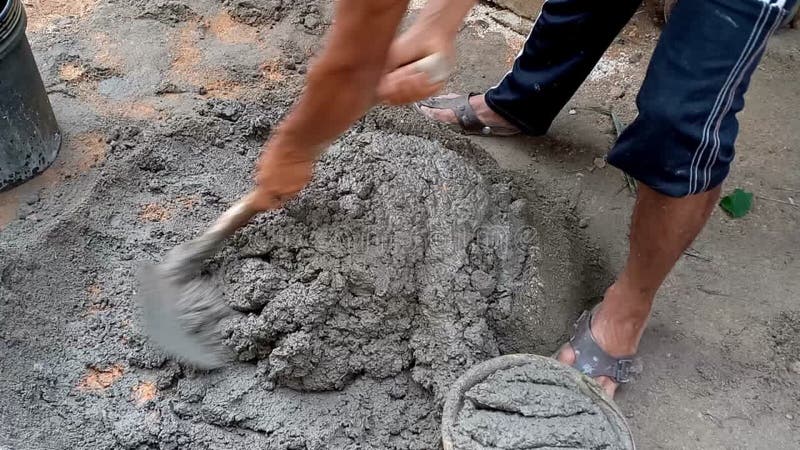 A Worker Mixing the Cement Mix on the Ground Stock Footage - Video of ...