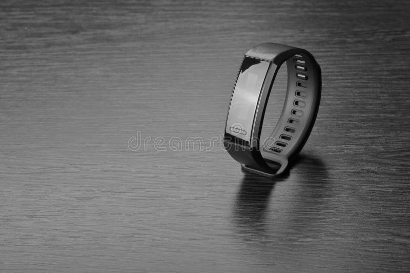 Activity Tracker, Also Known As a Fitness Tracker on a Dark Table Stock ...