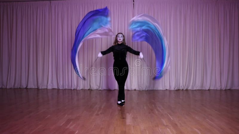An Actress Performs a Stunt on Stage, Spinning a Poi Using a Long Piece ...