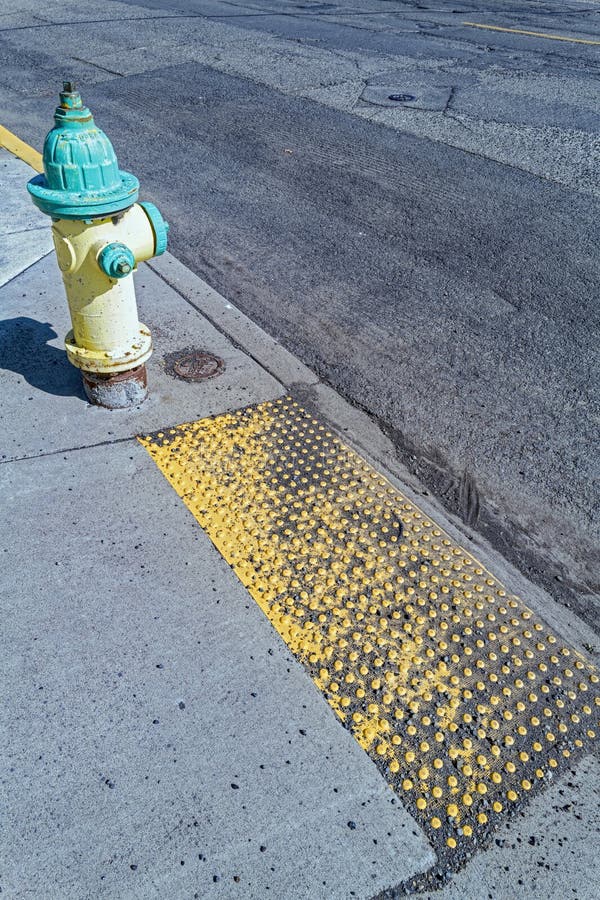 An ADA Warning Pad Next To a Fire Hydrant at a Pedestrian Crossing ...