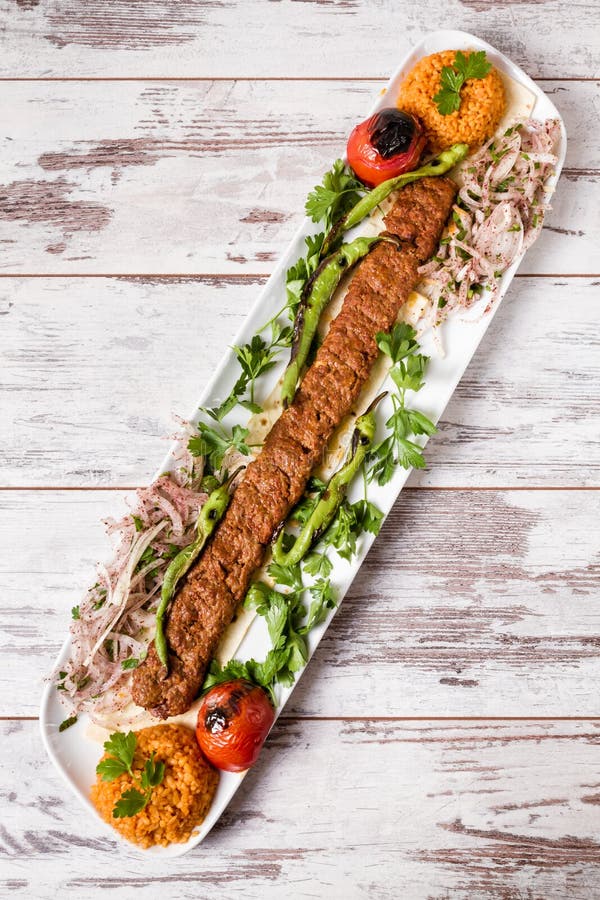 Adana Kebab Served with Green Vegetables in White Plate Stock Image ...