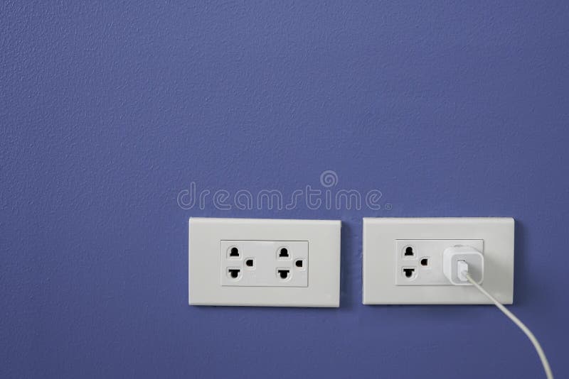 Adapter for Mobile Phone and Electric Plug on the Dark Blue Wall Stock ...