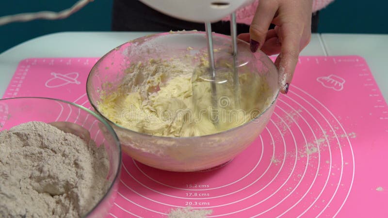 Add Flour To the Cream and Beat with a Mixer. Making Baking Dough Stock ...