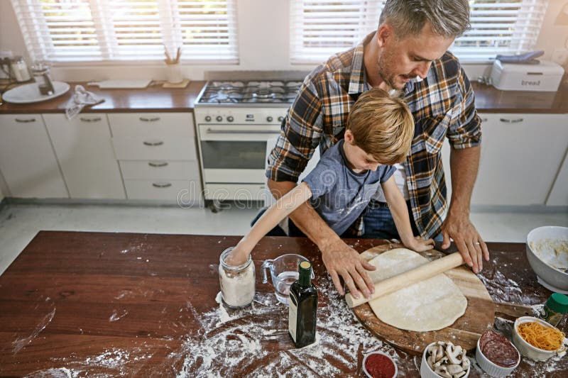 Add Some More Flour...a Father and His Son Making Pizza at Home. Stock ...