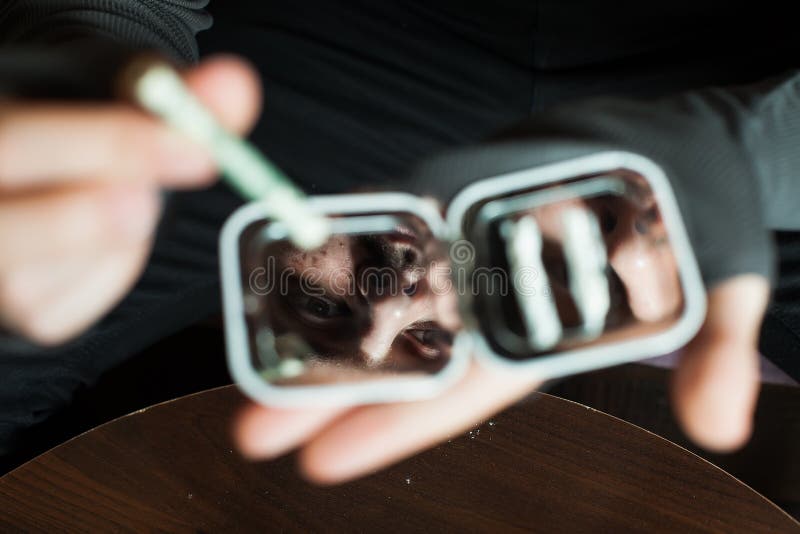Addict Smells Cocaine from a Mirror Closeup. Stock Image - Image of ...