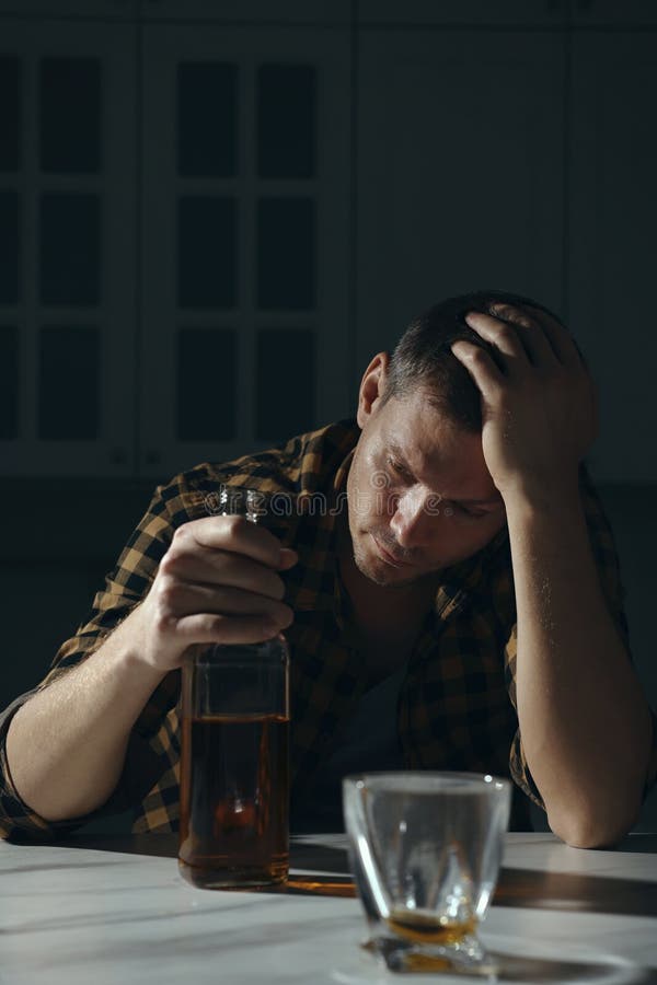 Addicted Man with Alcoholic Drink at Table in Kitchen Stock Photo ...