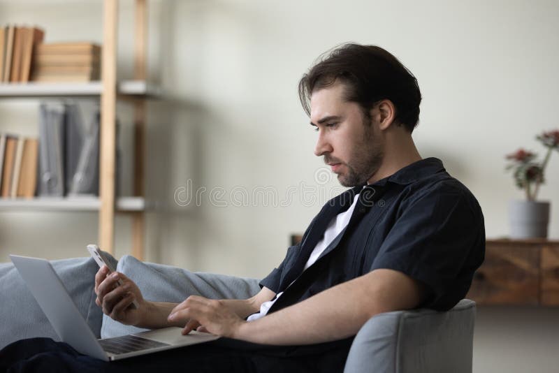 Addicted To Modern Technology Young Man Using Different Gadgets. Stock ...