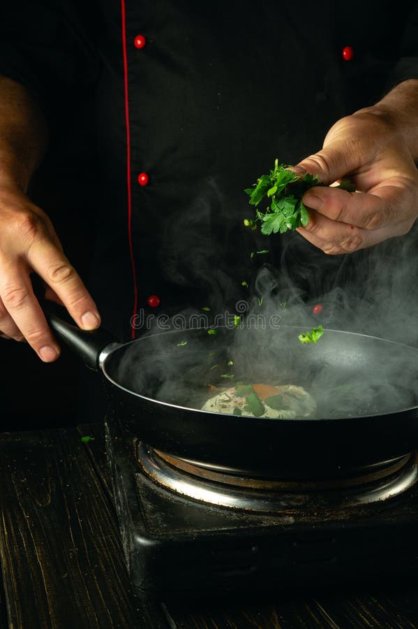 Adding Aromatic Herbs To a Hot Pan with Eggs. the Chef Prepares an Egg ...