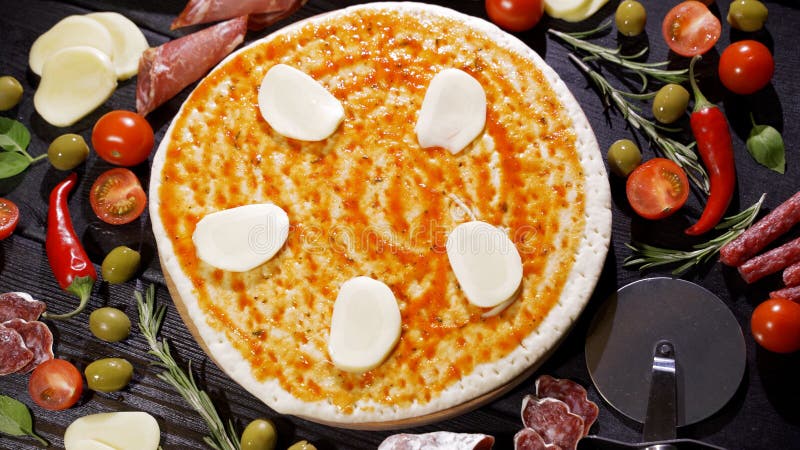 Adding cheese to the pizza stock photo. Image of mozzarella - 225513618