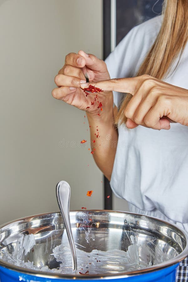 Adding Crushed Red Pepper To Mixing Bowl Stock Image - Image of metal ...