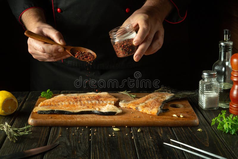 Adding Dry Spices To Fish Steaks for Aroma and Taste. Asian Cuisine ...