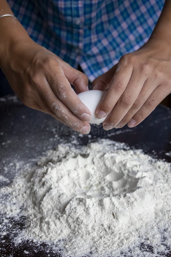 Dough Preparation Process of Adding Egg To the Flour Stock Photo ...