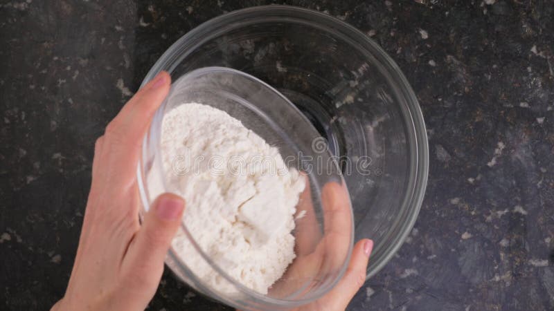 Adding Egg To Flour, Baker in Bowl. Close Up Shot of Pouring Egg in ...