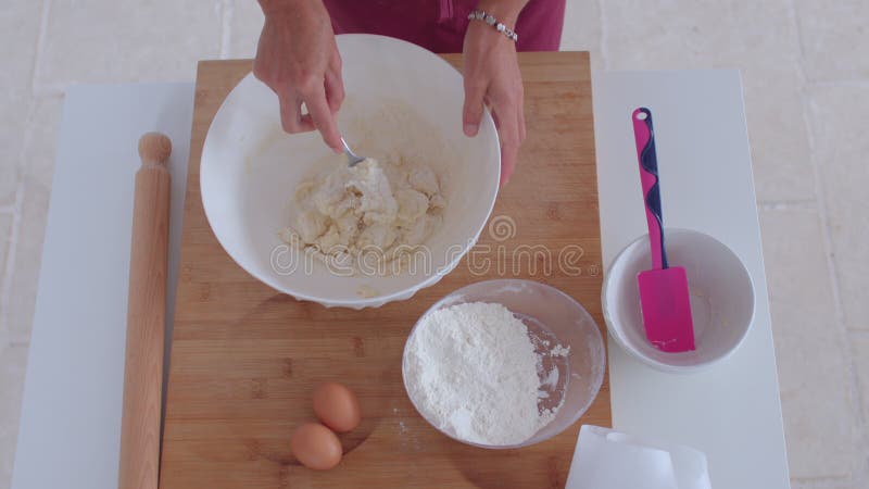 Adding Flour To Mix with the Egg. Making Dough for Food in the Kitchen ...