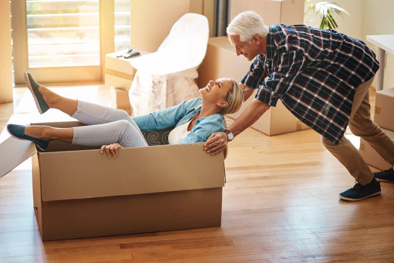 Adding the Fun Factor To Moving Day. a Happy Mature Couple Having Fun ...