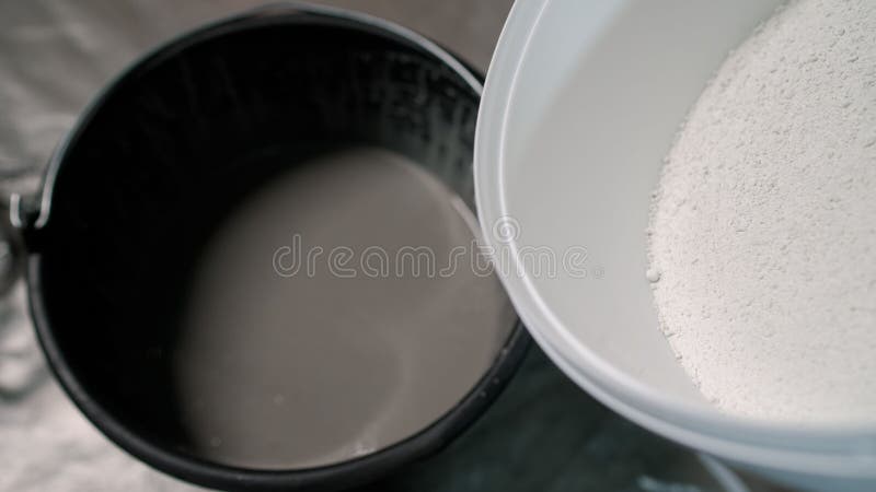 Adding Hardener To a Bucket of Plaster. the White Solution is Poured ...