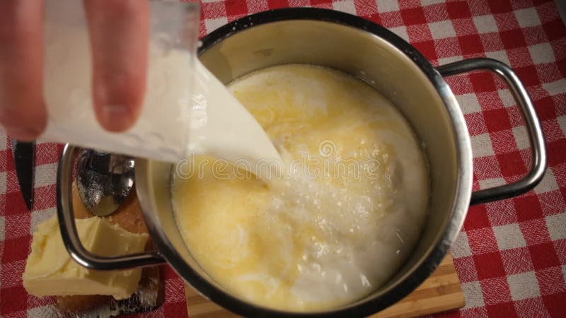 Adding milk to the pot stock footage. Video of flour - 265283054
