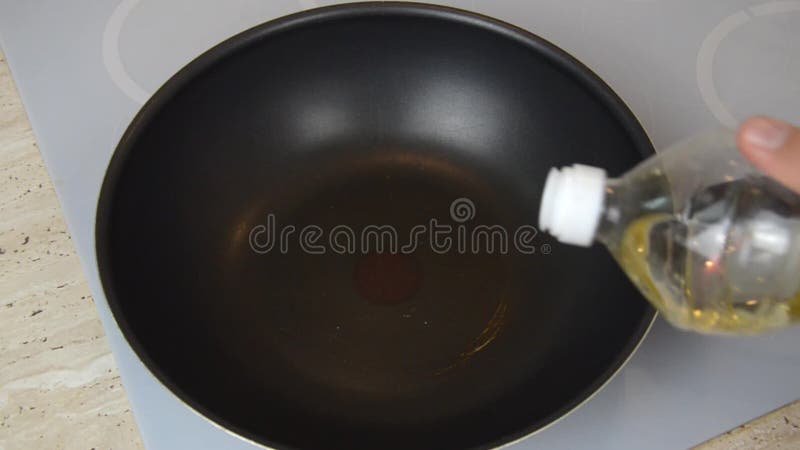 Adding oil into a wok stock footage. Video of bottle - 129295530