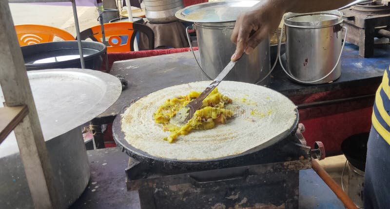 Adding Potato Masala To Make Masala Dosa on a Frying Pan Stock Photo ...