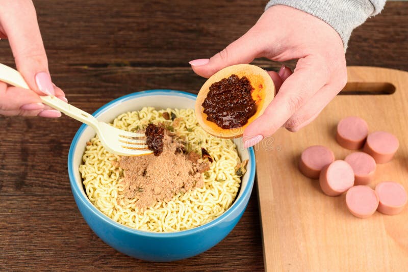 Adding Sauce and Soup Dressing To Instant Noodles. Stock Photo - Image ...