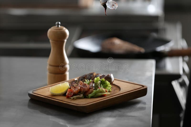 Adding Sauce To Meal on Table in Restaurant Kitchen. Cooking Food Stock ...