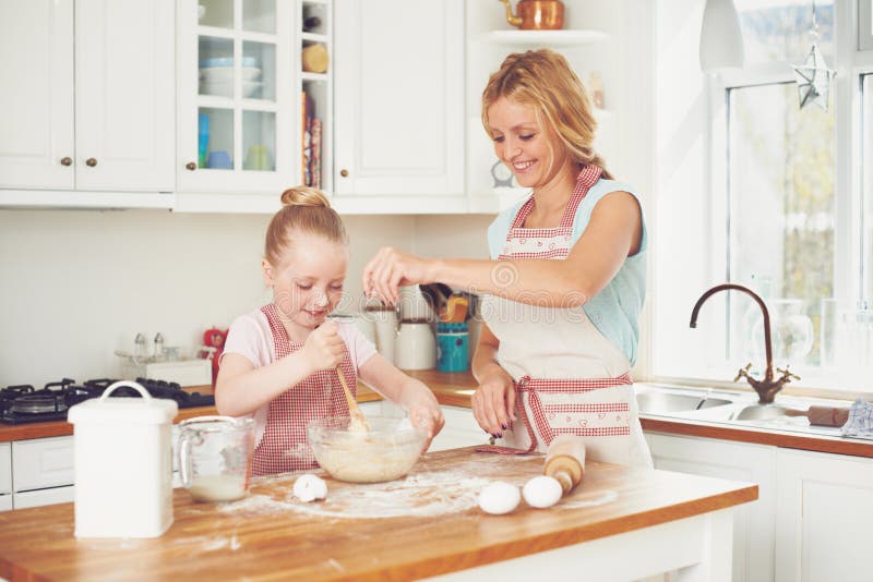 Adding a Secret Ingredient. Cute Little Girl Baking in the Kitchen with ...