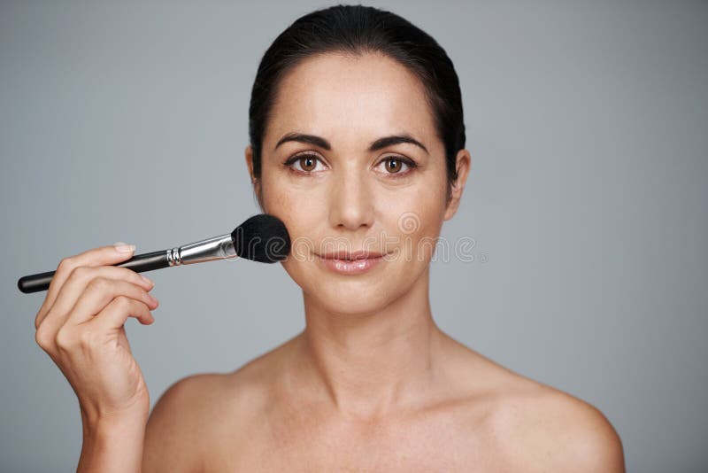 Adding Some Colour To Her Cheeks. Cropped Studio Portrait of a Woman ...