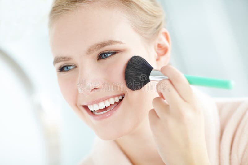 Adding Some Subtle Colour. a Smiling Woman Applying Blush with ...