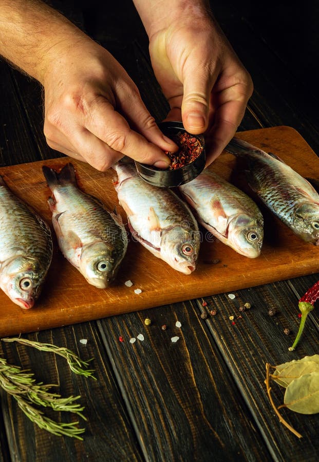 Adding Spices To Fresh Fish by the Hands of a Chef. the Process of ...