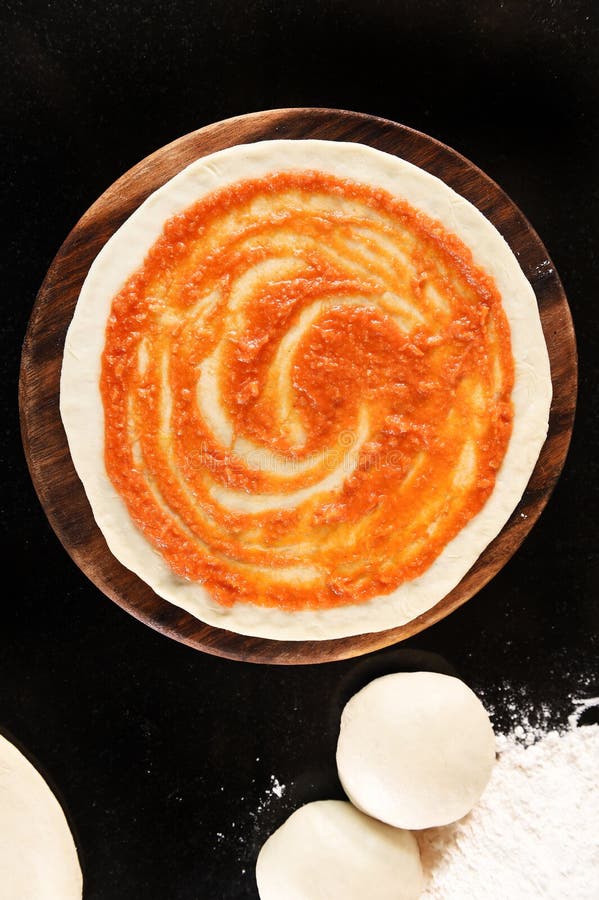 Adding Tomato Sauce To Pizza Base Stock Image - Image of baking, ladle ...