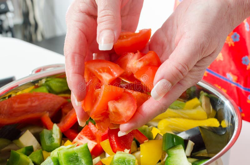 Adding Tomatoes Pieces into Saucepan Stock Photo - Image of board, meal ...