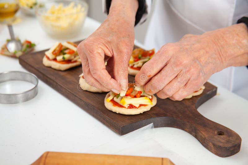 Adding Toppings To the Mini Pizzas. Delicious Homemade Mini Pizzas ...