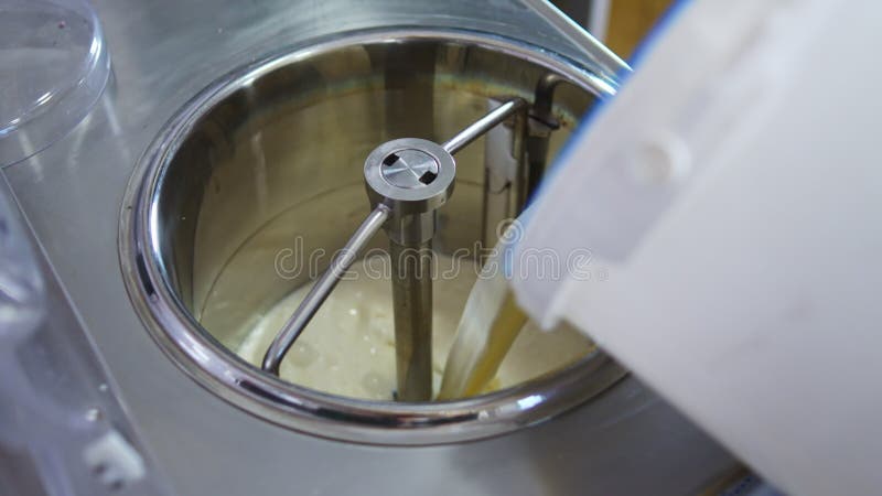 Adding Vanilla Ice Cream from Bucket To the Pasteurization Machine in a ...