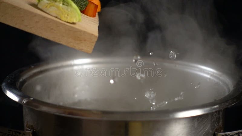 Adding a Vegetables To Boiling Water in Pan, Slow Motion Stock Video ...