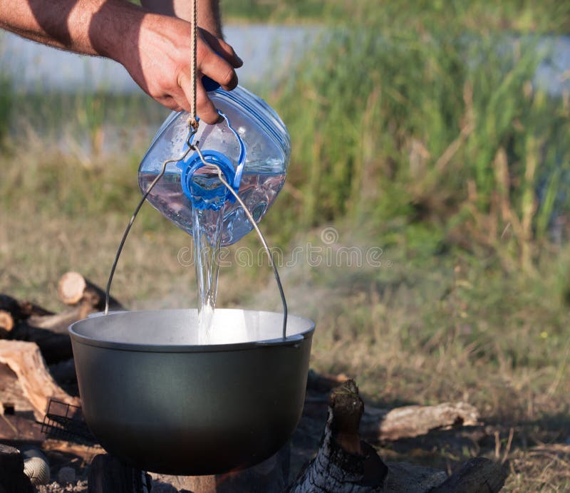 Adding Water from a Bottle in Cauldron Stock Image - Image of cauldron ...