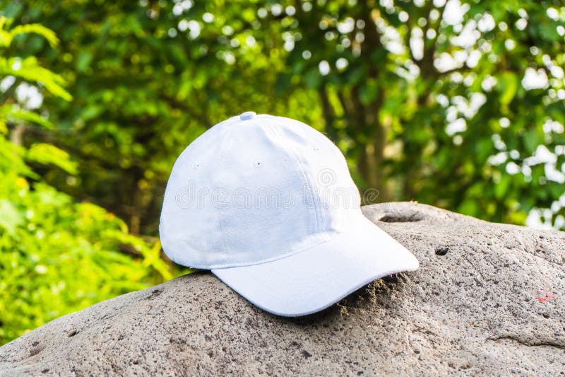 The Addition of a White Cap Hat Above a Rock Near the Forest Creates a ...