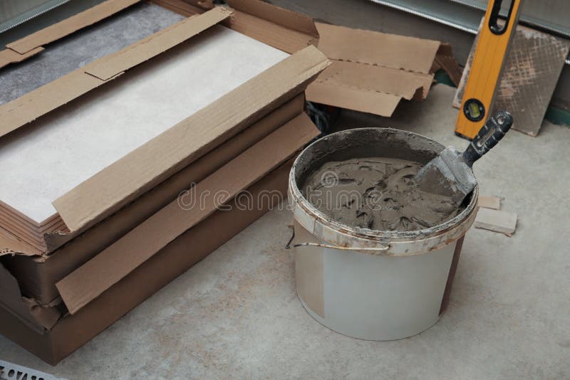 Adhesive Mix, Bubble Level and Ceramic Tiles on Floor Indoors Stock ...