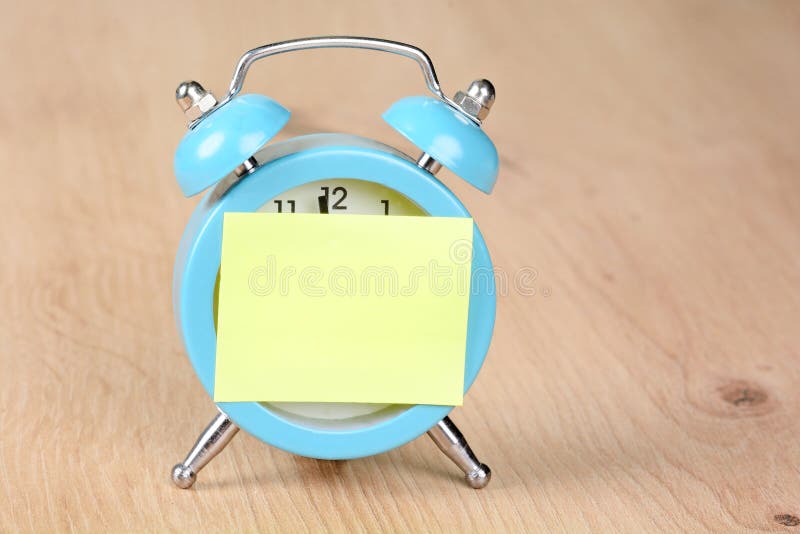 Adhesive Note on a Blue Alarm Clock Stock Photo - Image of writing ...