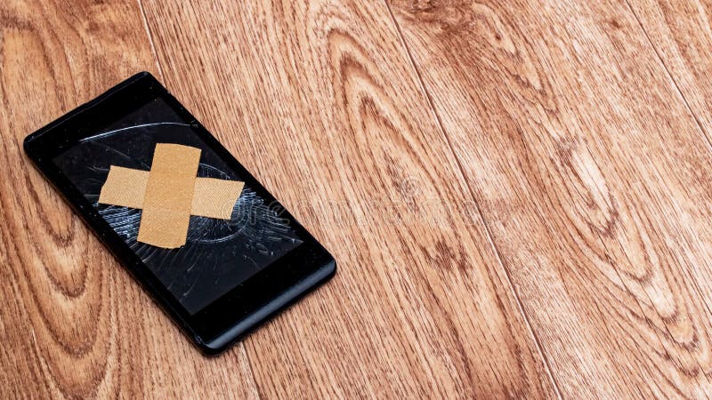 Adhesive Plaster on a Broken Phone Display on Wooden Table Stock Photo ...