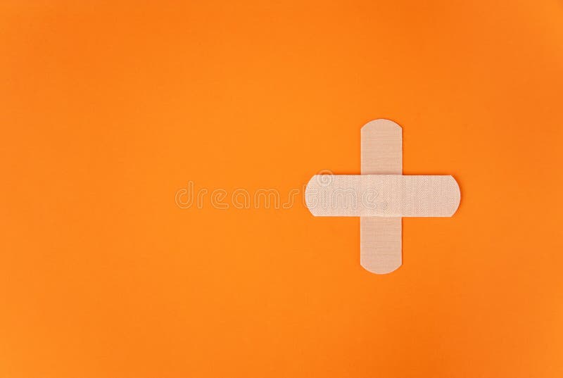 Adhesive Plaster in Shape of Plus Sign Isolated on Orange Background ...