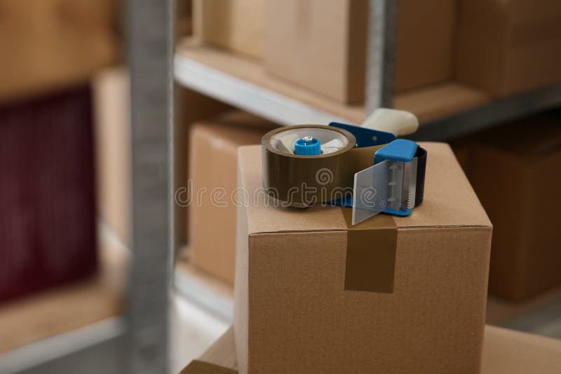 Adhesive Tape Dispenser on Cardboard Box Indoors. Space for Text Stock ...