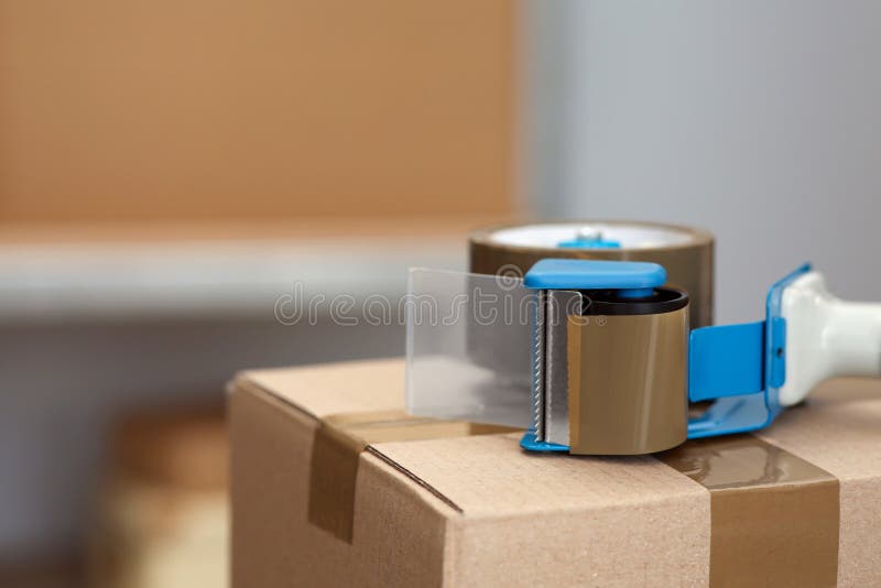 Adhesive Tape Dispenser on Cardboard Box Indoors. Space for Text Stock ...