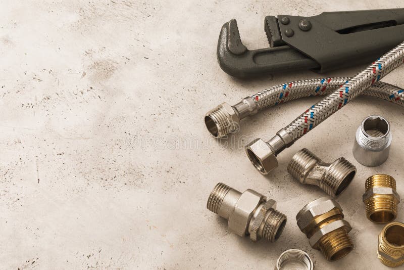 Adjustable Wrench, Flexible Water Hoses and Connecting Adapters on the ...