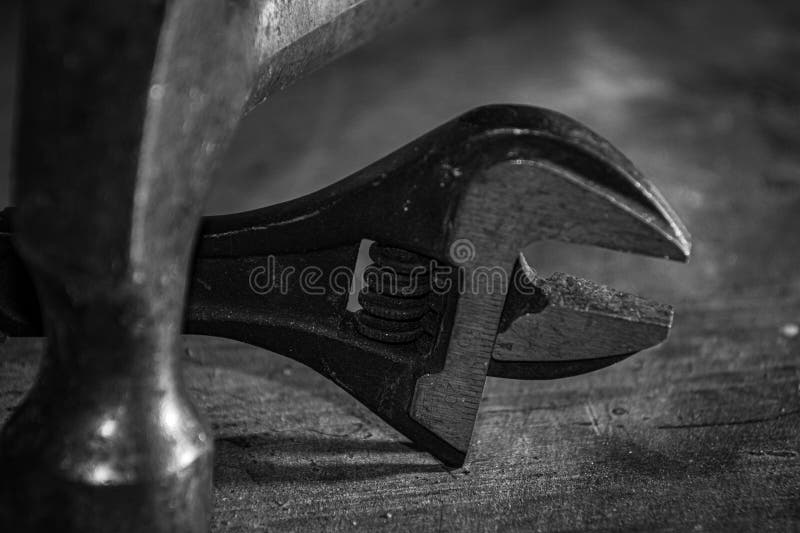 Adjustable Wrench and Hammer Left on the Workbench Stock Image - Image ...