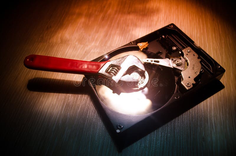 Adjustable Wrench Turn Off a Hard Disk. on a Dark Background Stock ...