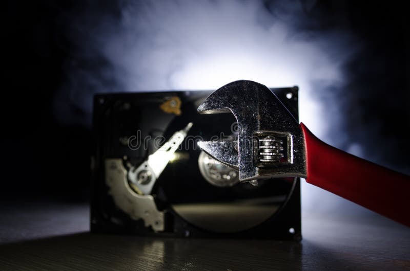 Adjustable Wrench Turn Off a Hard Disk. on a Dark Background Stock ...