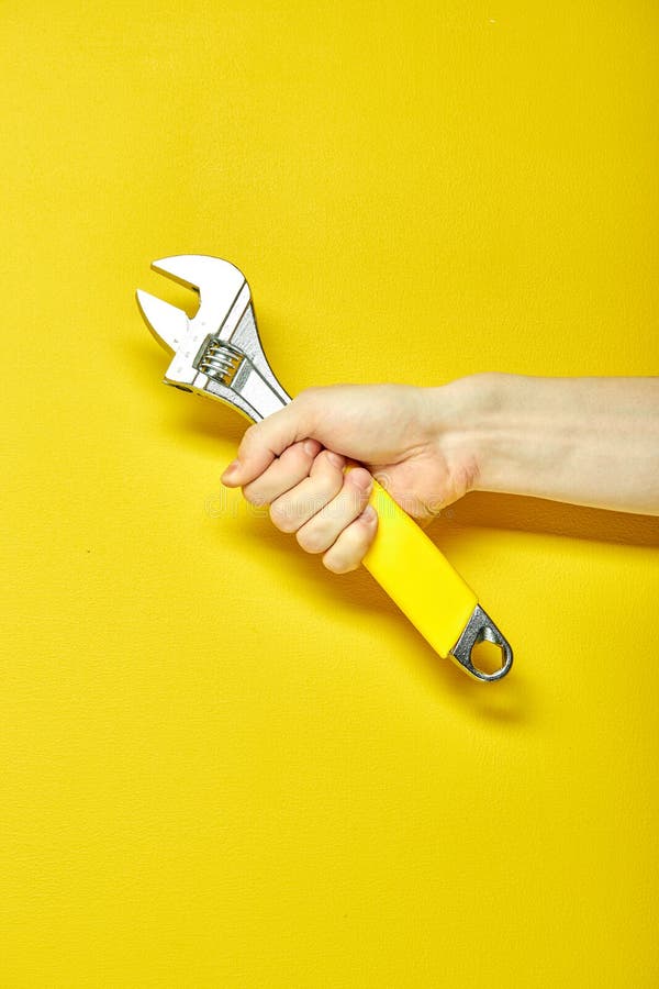 Adjustable Wrench with Yellow Rubberized Handle, Isolated on Yellow ...